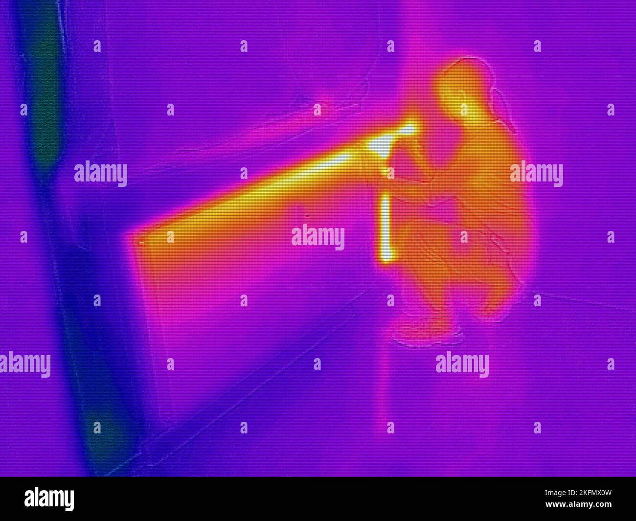 infrared thermal photography of a young woman adjusting the temperature ...