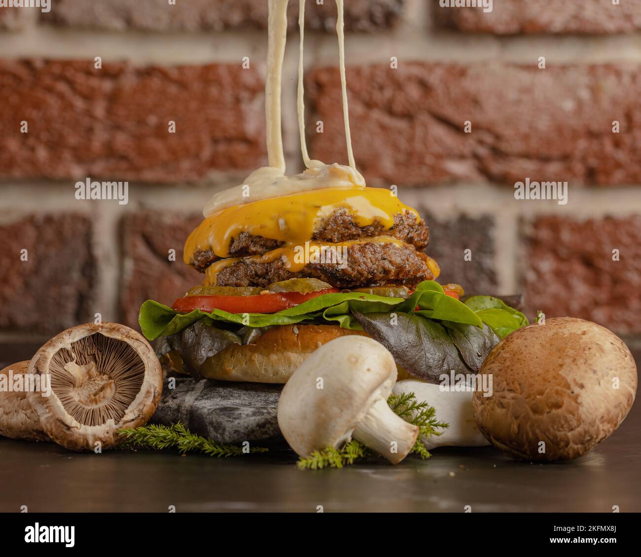 cheese beef burger with stretching cheese Stock Photo - Alamy