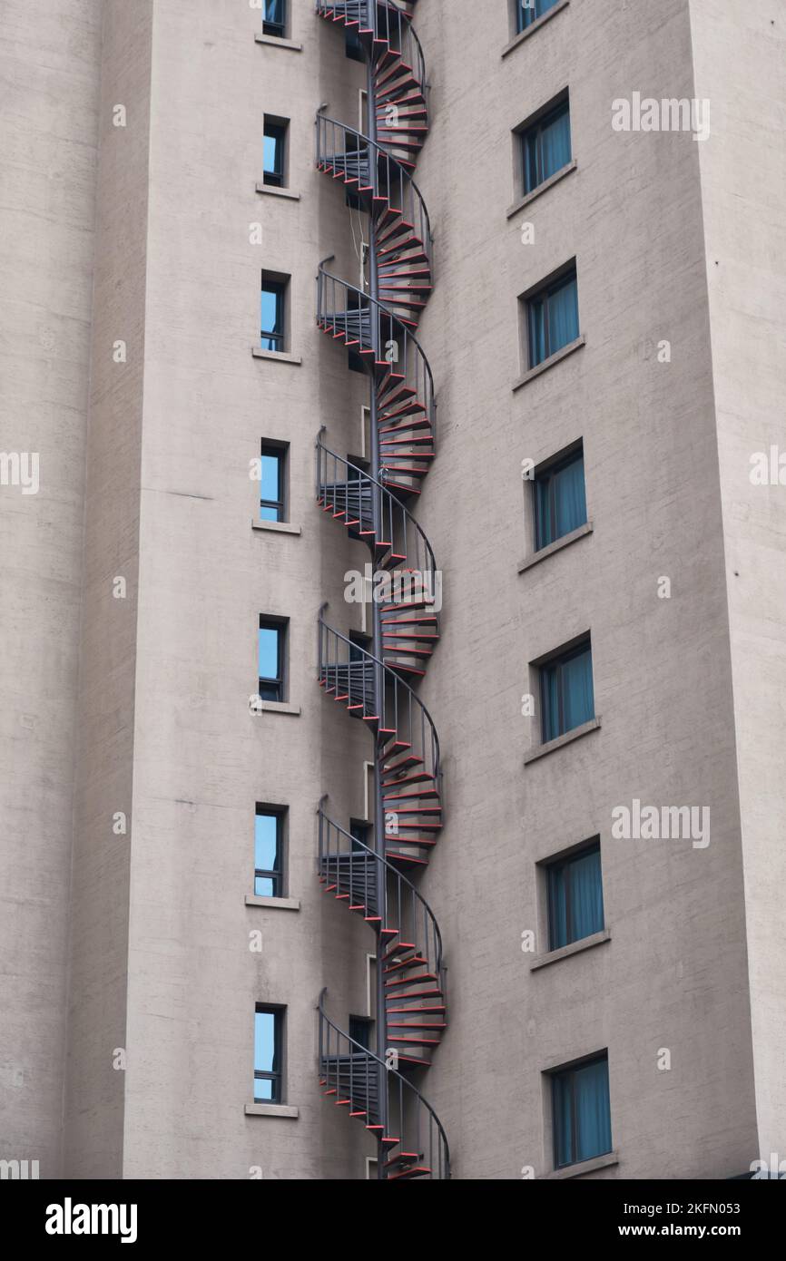 A vertical low-angle of a high apartment building with a spiral ...