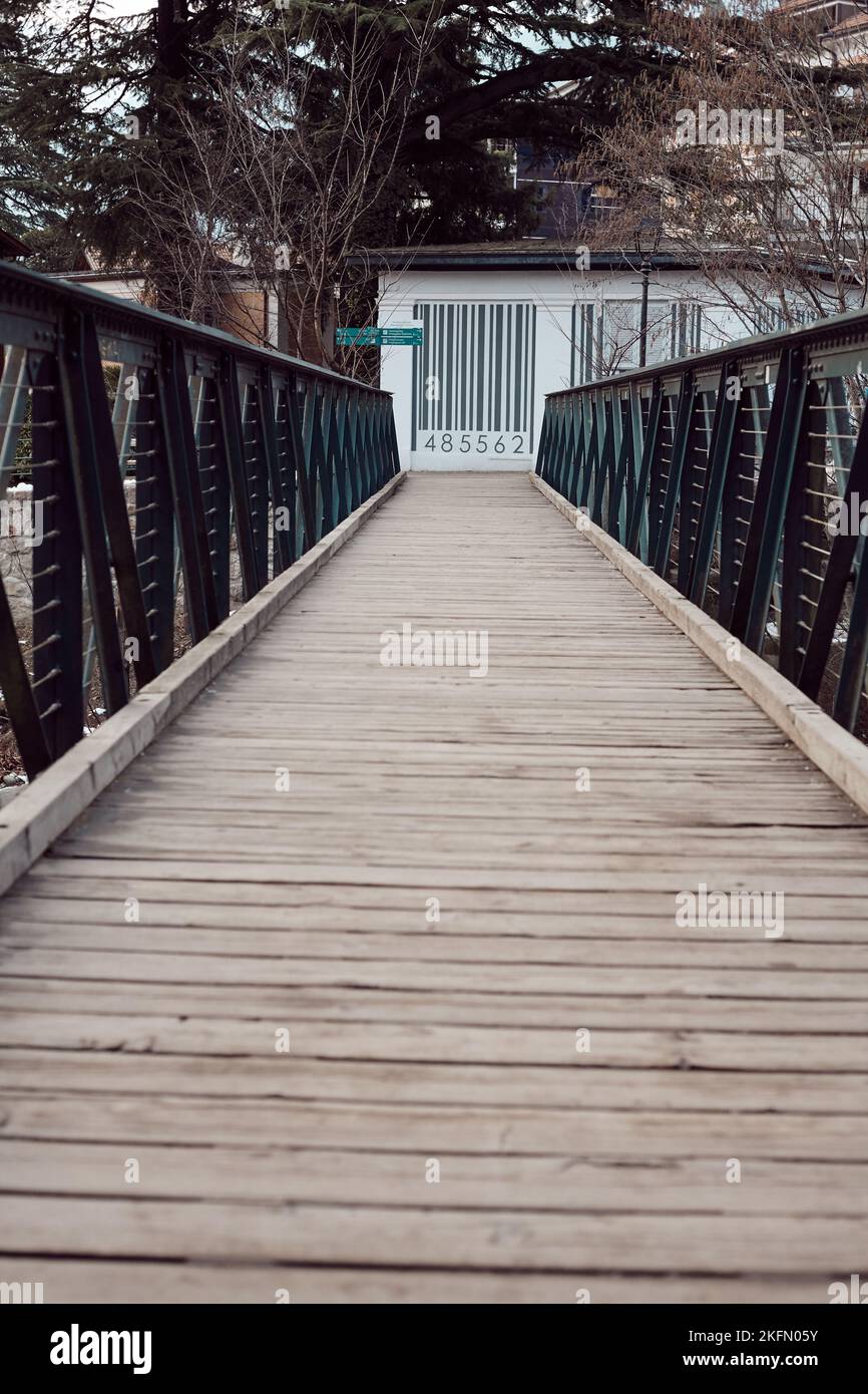 A vertical high-angle of a bridge with wooden floor and metallic dark ...