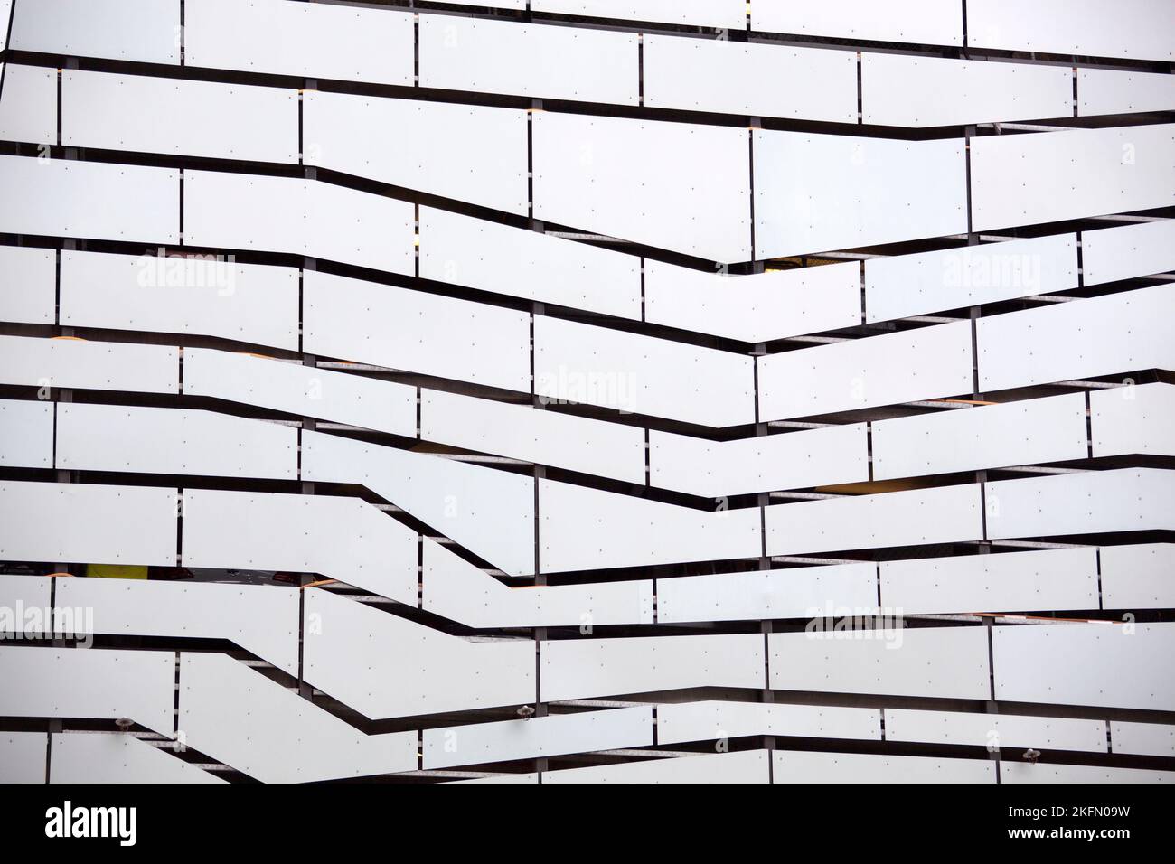 The abstract view of an asymmetrical exterior of a modern building in ...