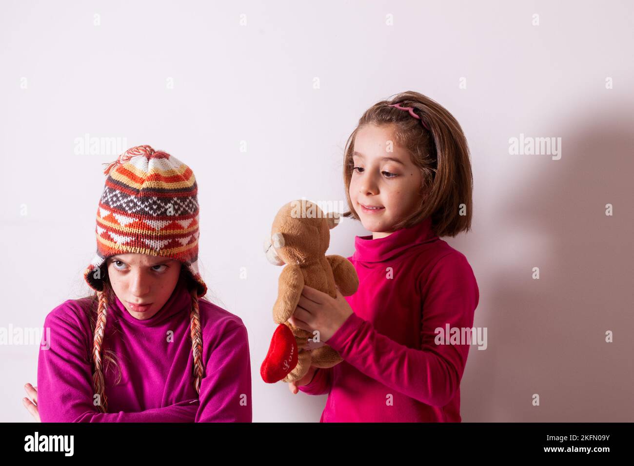 Greedy kids concept. Sisters relations issues. Share toys with friends ...