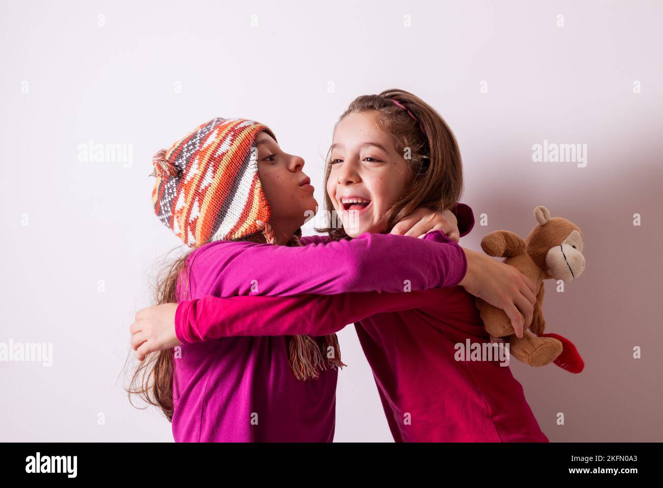 Happy and healthy young little girls hugging and smiling. Best friend ...