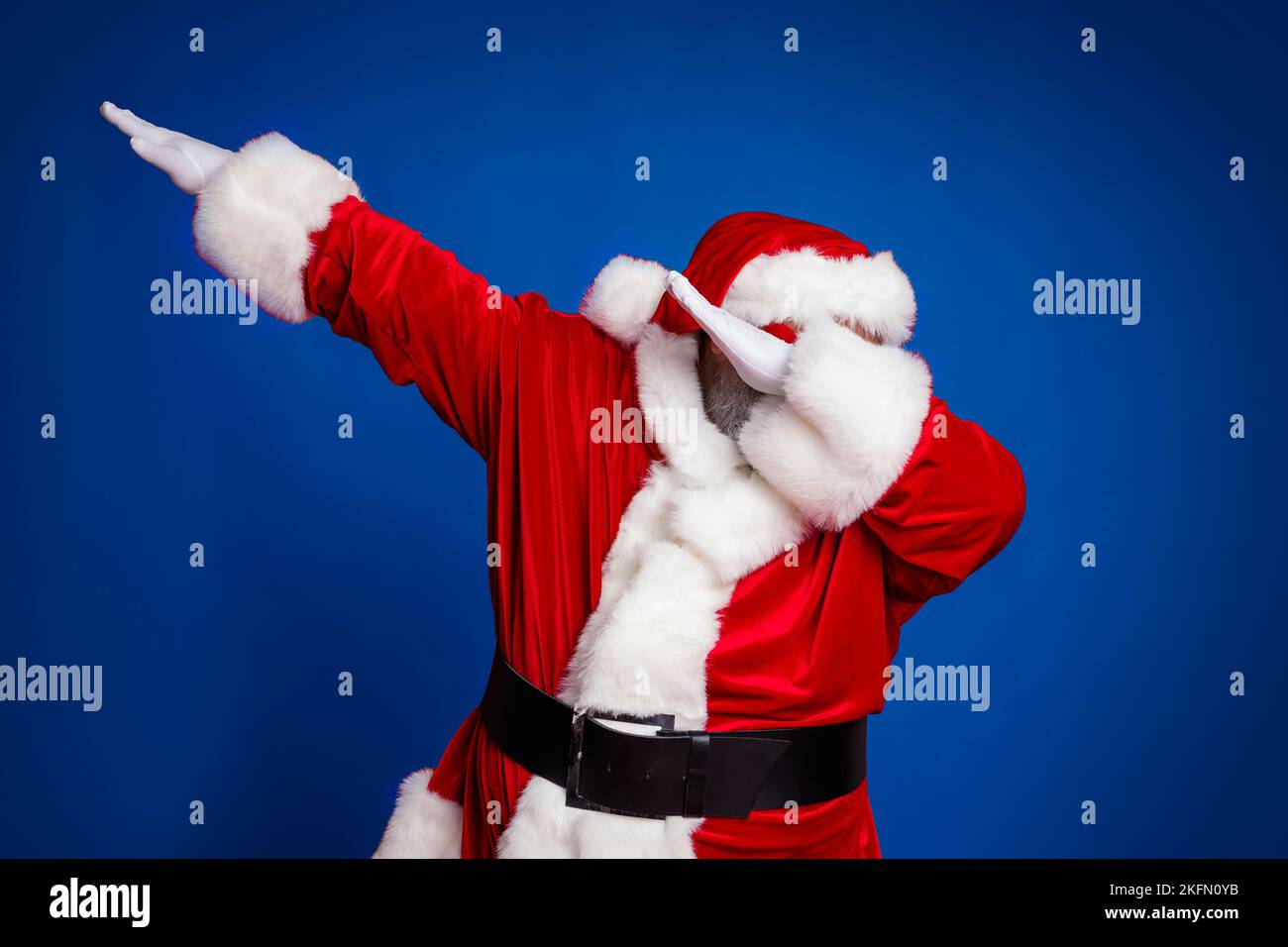 Photo of funky positive carefree old man dance make dab move wear santa ...