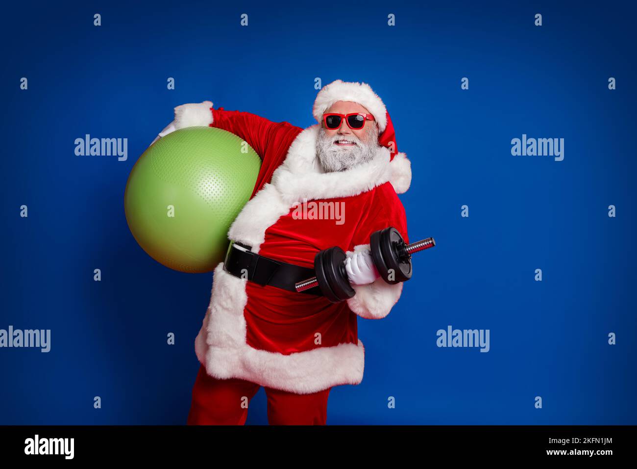 Photo of handsome strong santa claus wear red costume hat dark holding ...