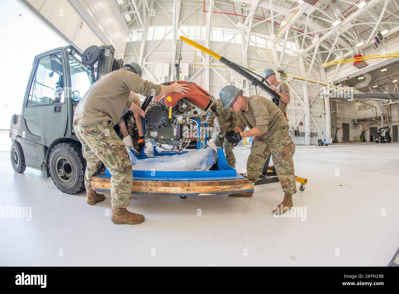 Engine mechanics with the 157th Maintenance Group suspend an auxiliary ...