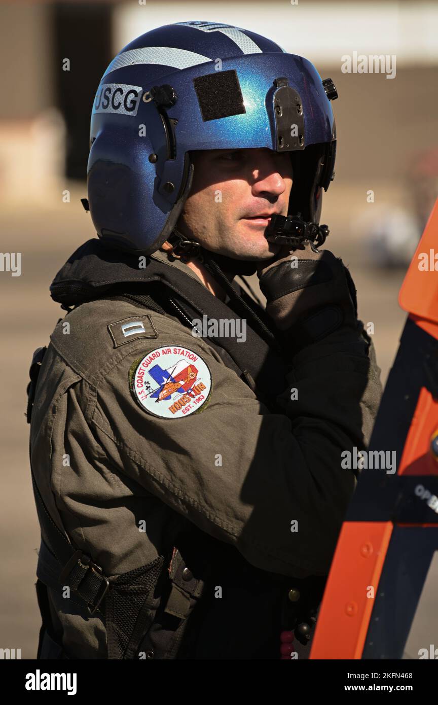 A Coast Guard Aviation Training Center Mobile pilot adjusts his helmet ...