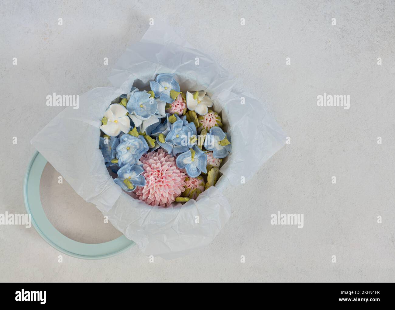 Zephyr bouquet of flowers in a gift box on a light background, top view ...