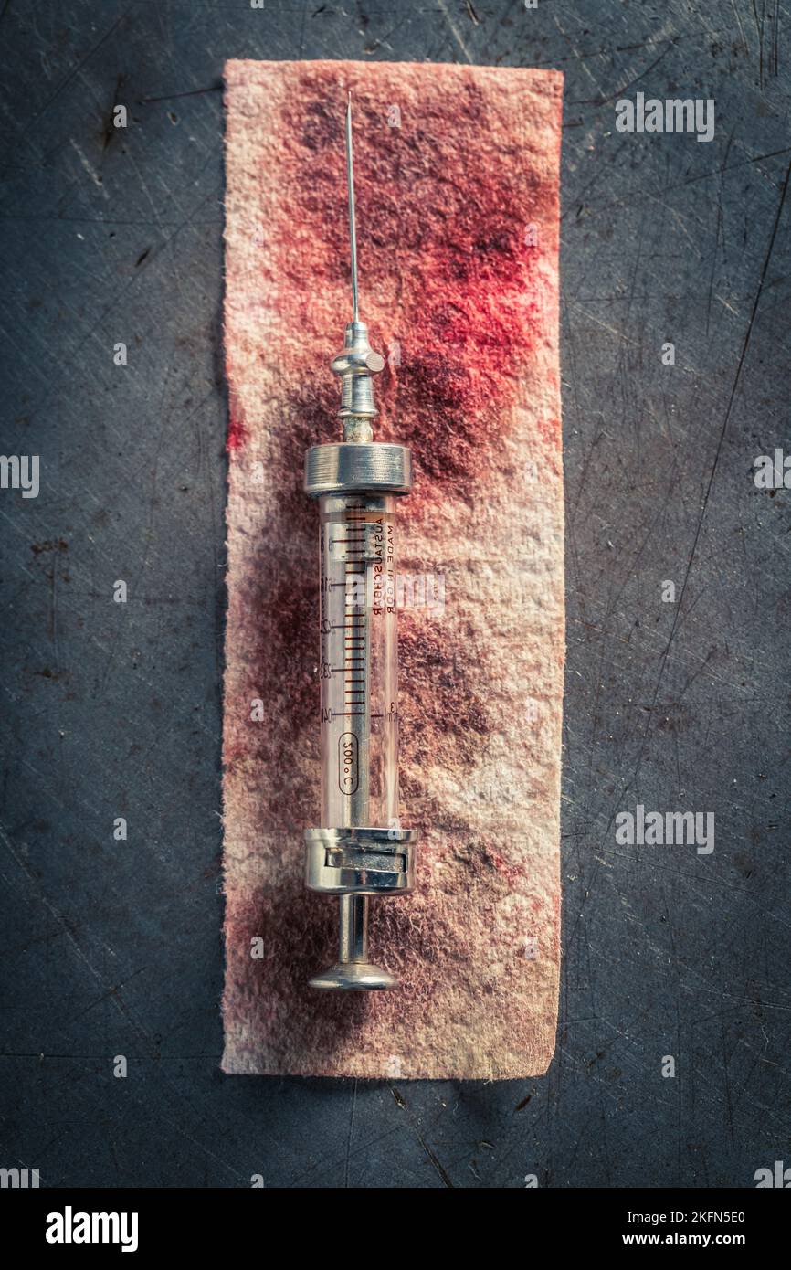 Unsterile and retro needle and syringes in steel container. Old ...