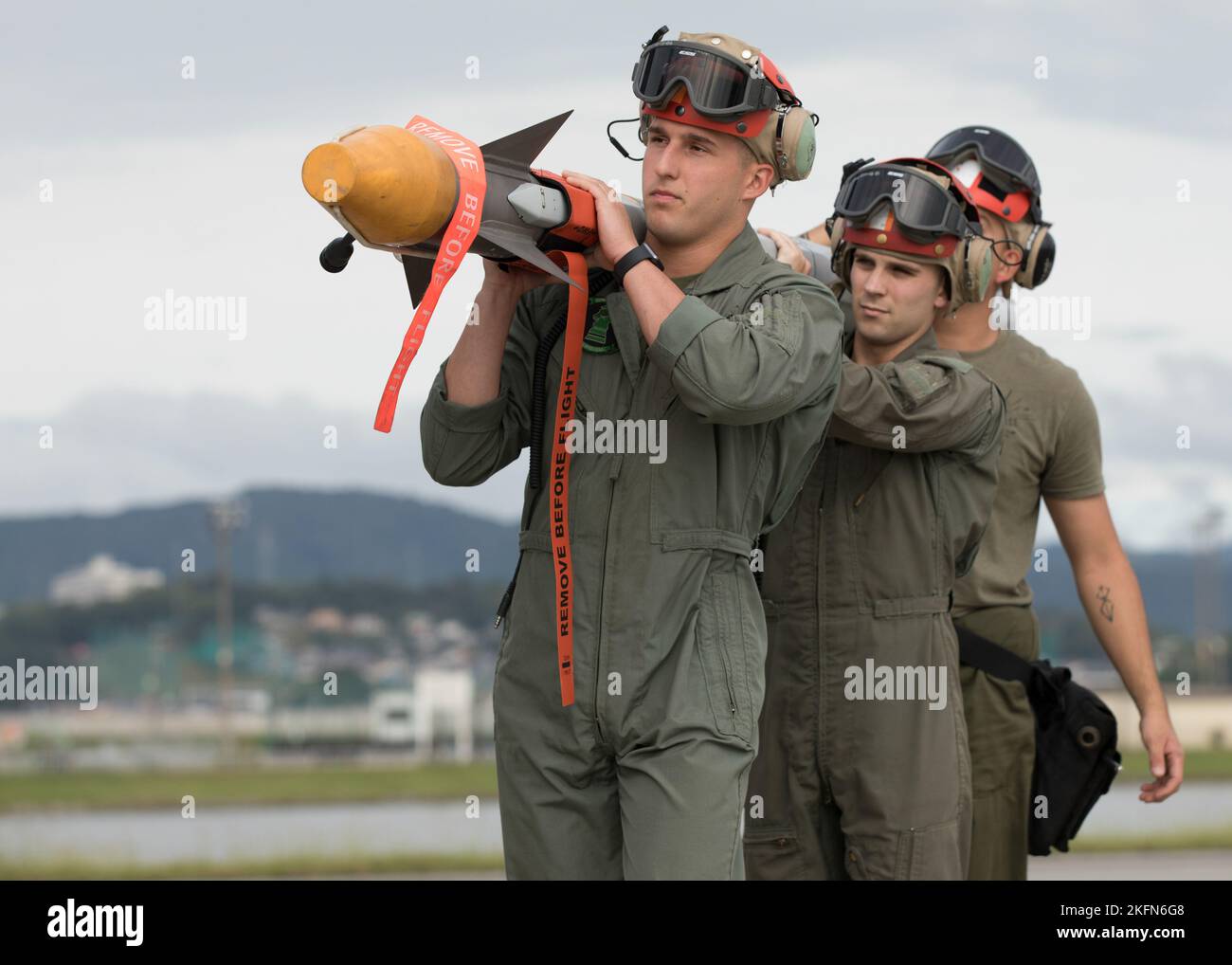 U.S. Marines with Marine Fighter Attack Squadron (VMFA) 121 transport ...