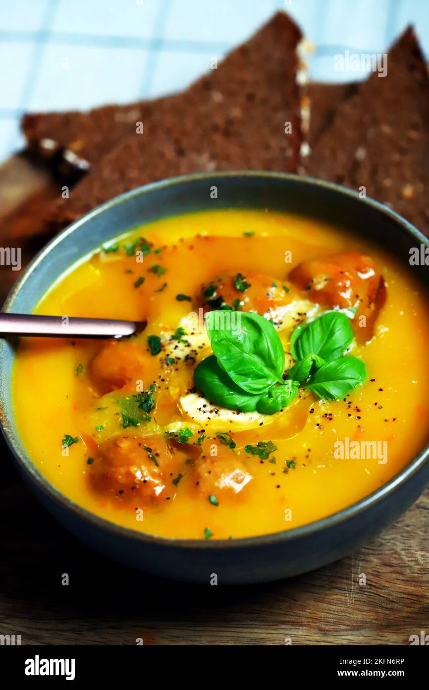 Pumpkin carrot soup with meatballs in a bowl. Autumn menu Stock Photo ...