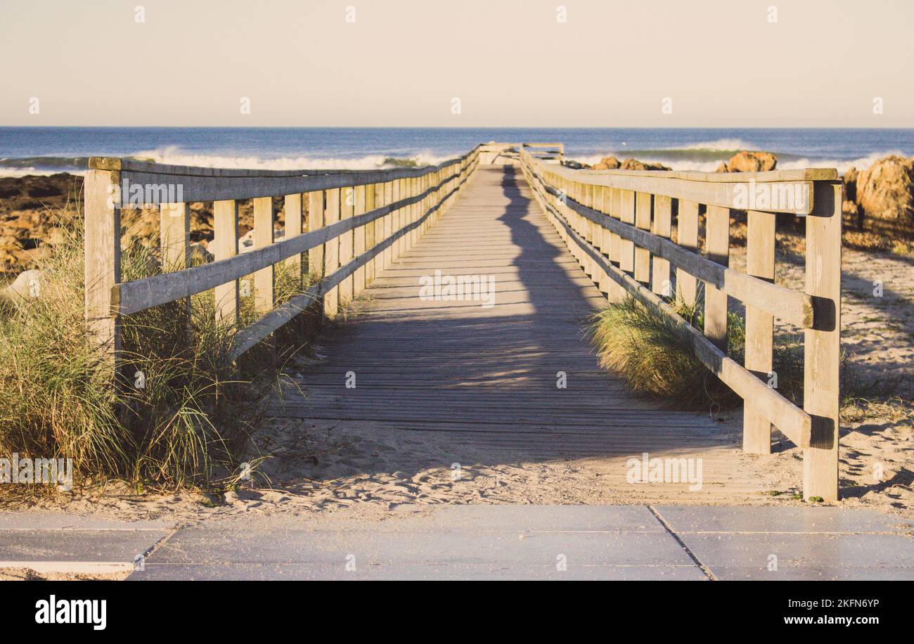 Wooden pier with grass on Atlantic ocean coast, Portugal. Wooden ...
