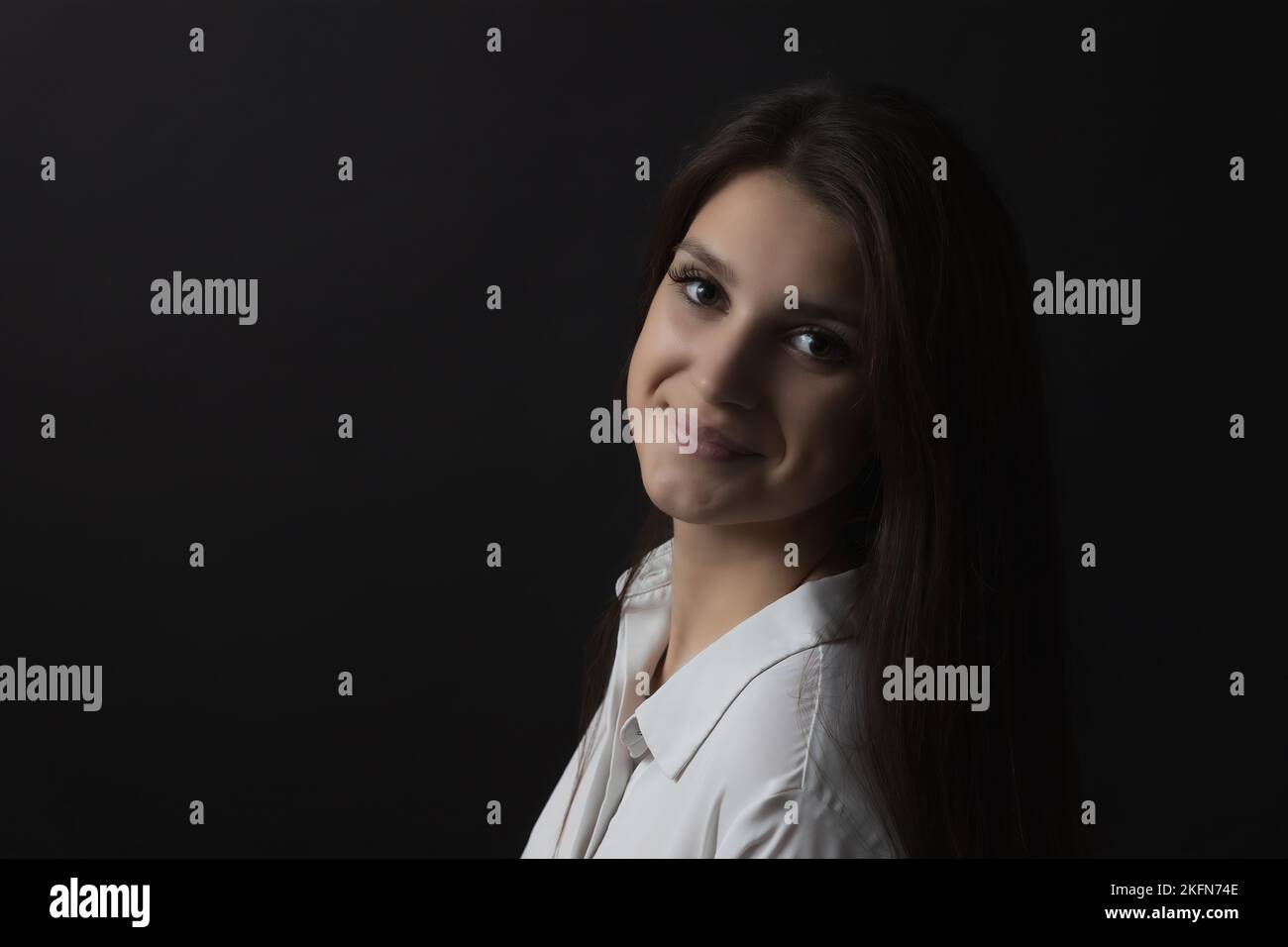 Smiling beautiful girl. Low key studio portrait. Horizontally Stock ...