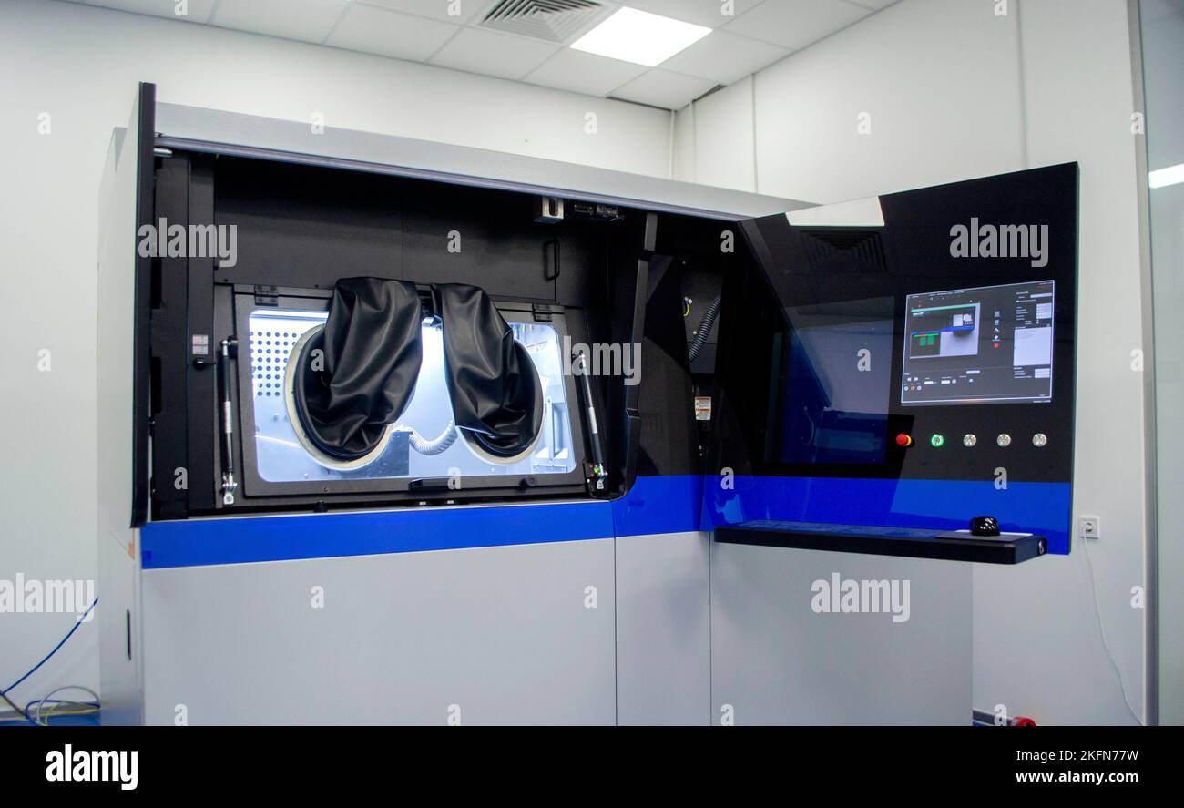 Industrial 3d printer for metal powder with hands wearing big black ...