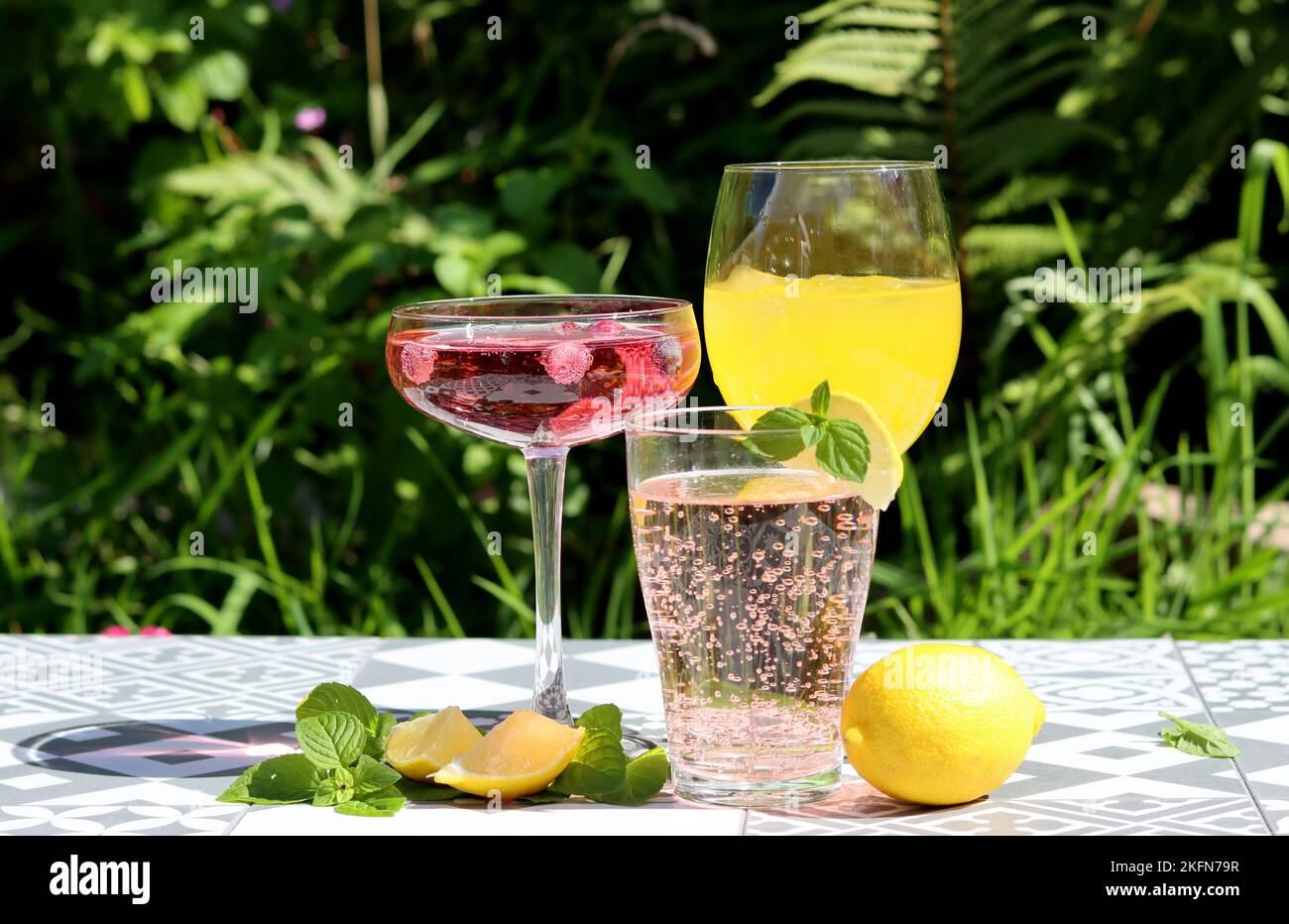 Refreshing summer cocktails on a garden table. Close up photo of ...