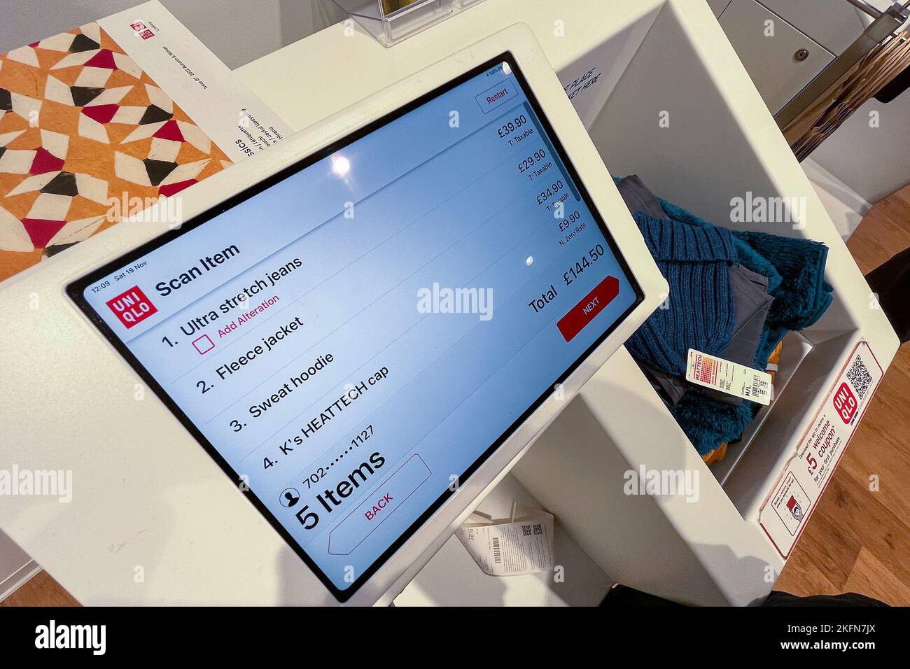 Self check out tills at uniqlo inside Battersea Power Station in south ...