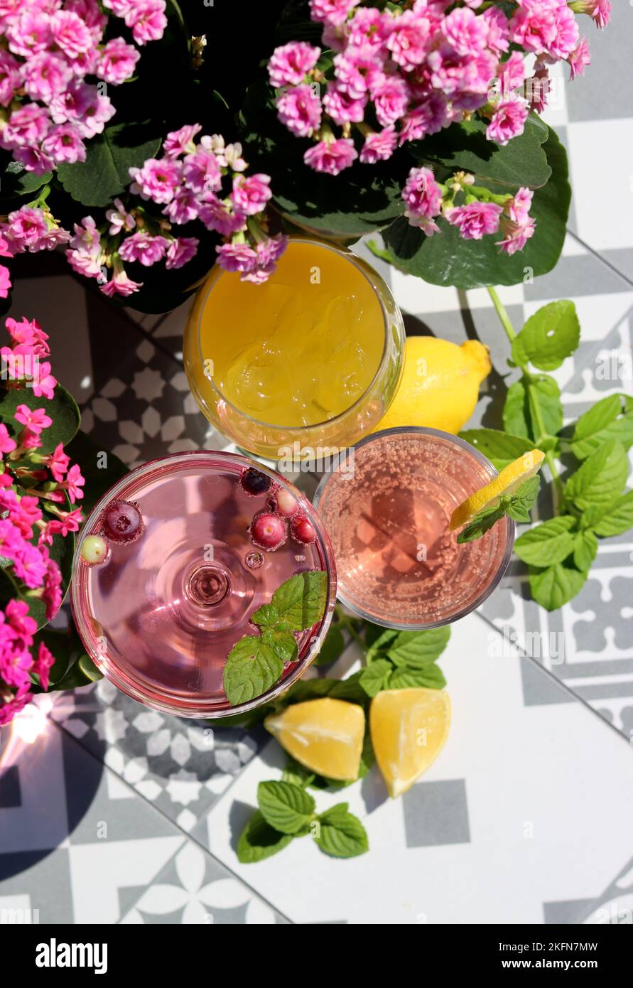 Refreshing summer cocktails on a garden table. Close up photo of ...