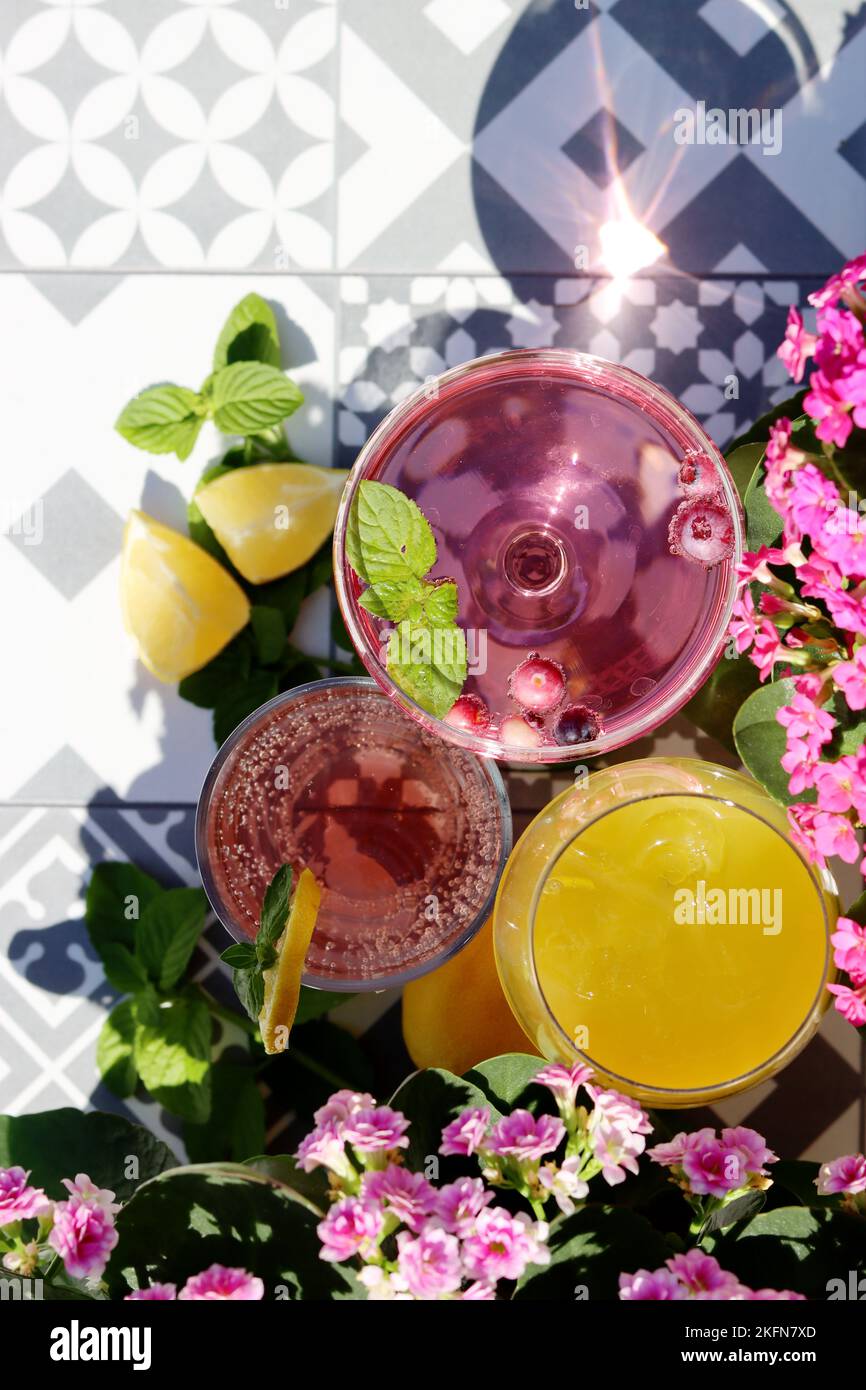 Refreshing summer cocktails on a garden table. Close up photo of ...