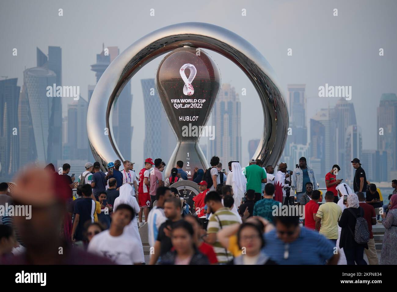 People look at the official World Cup countdown clock on the Corniche ...