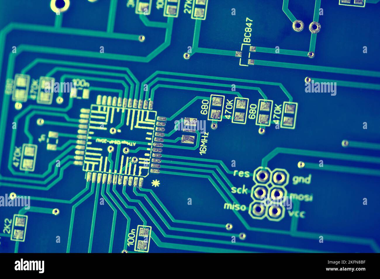 Macro shot of the back side of a circuit board. Close up of the blue ...