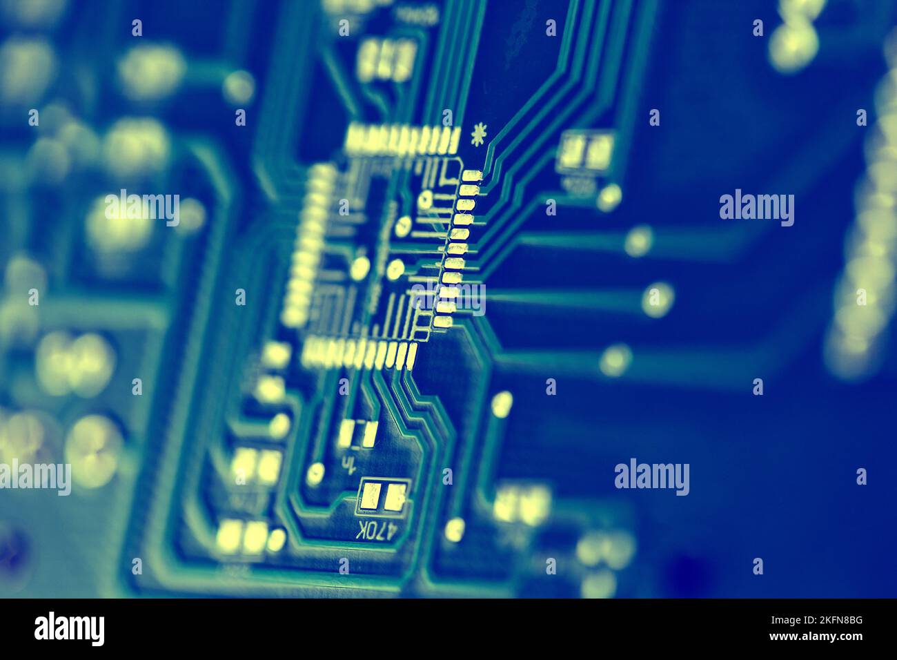 Macro shot of the back side of a circuit board. Close up of the blue ...