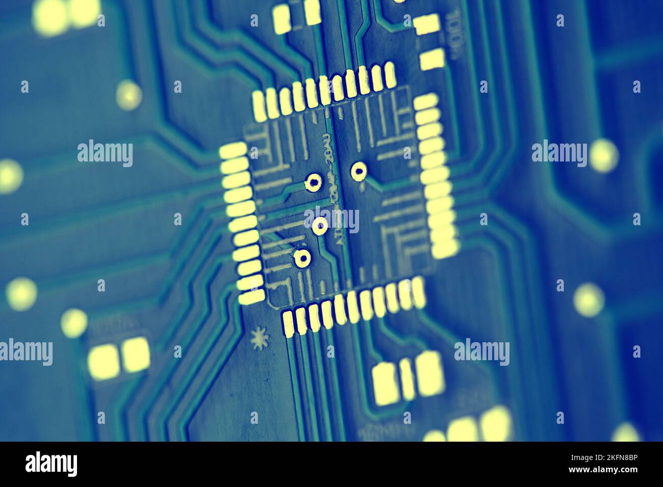 Macro shot of the back side of a circuit board. Close up of the blue ...