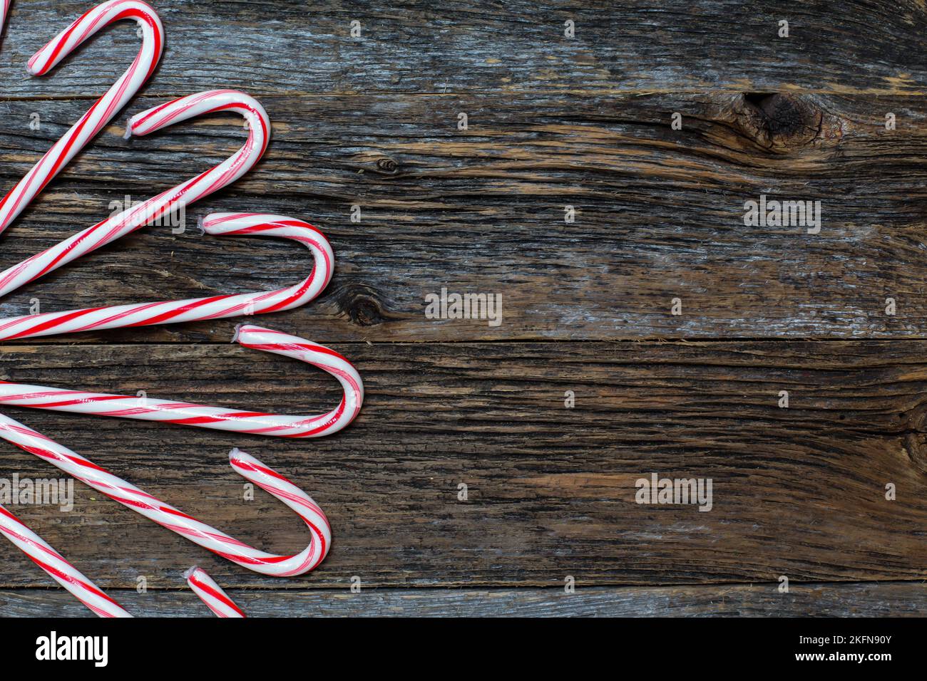 Rustic wood with candy canes Stock Photo - Alamy