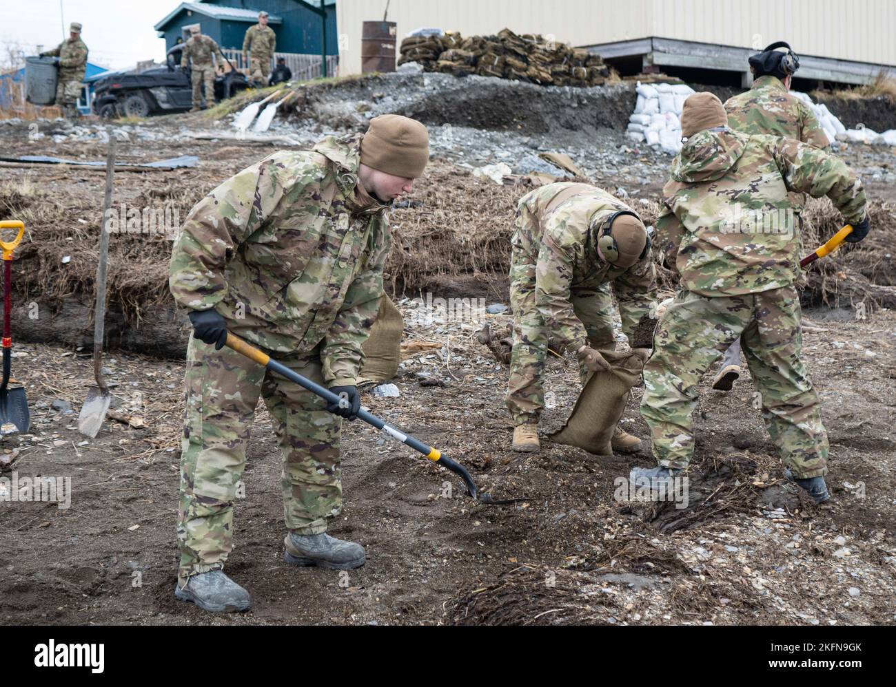 Alaska Air and Army National Guardsmen, assigned to Joint Task Force- Alaska, fill and place ...