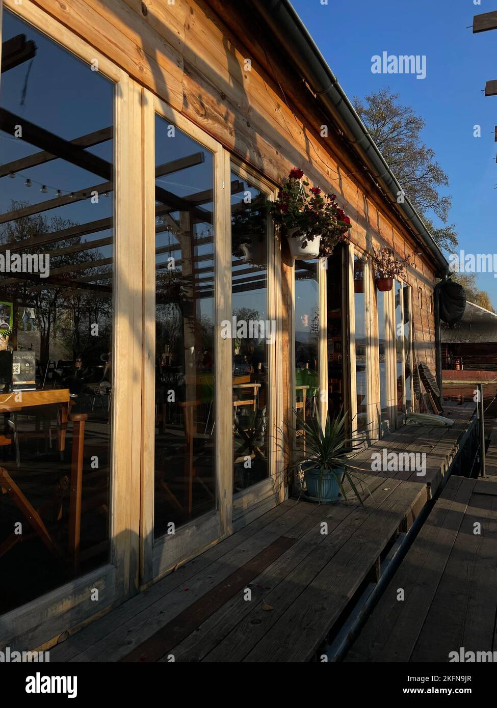 A glass veranda of cafe in sunny day Stock Photo - Alamy