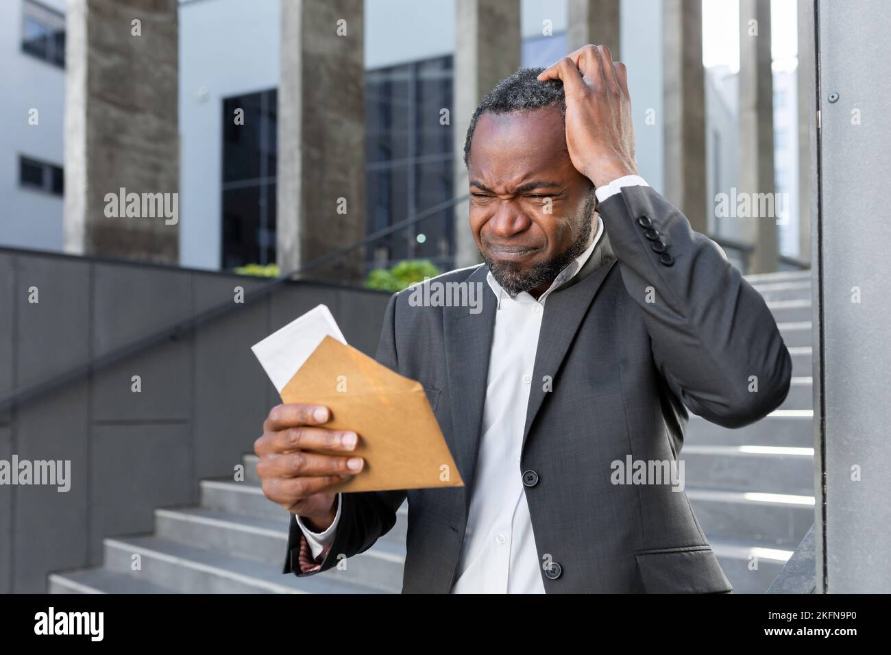 Bad news, bankruptcy notice, businessman outside office building ...