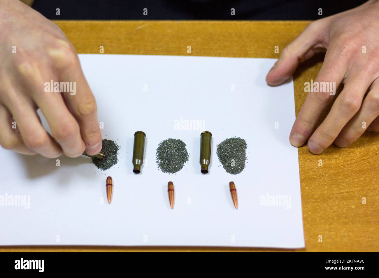 A man's hand pours gunpowder from a shell close-up Stock Photo - Alamy