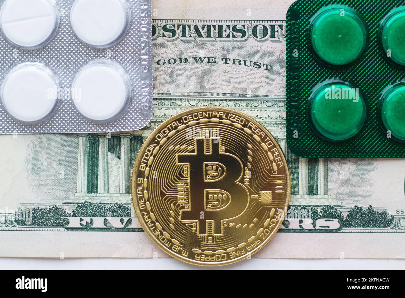 Bitcoin coin with pills is located on the dollar bill Stock Photo - Alamy