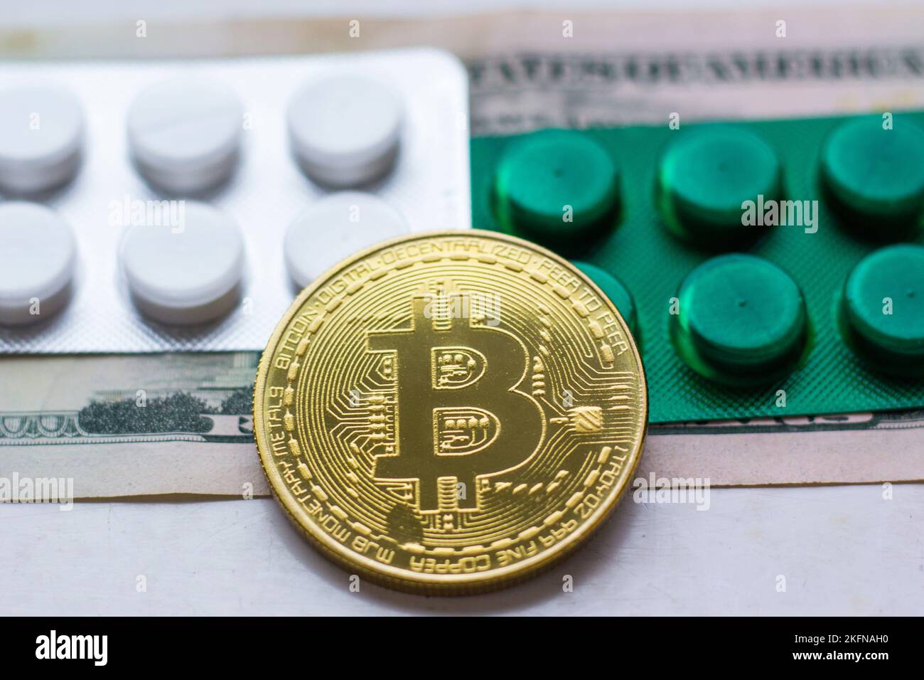 Bitcoin coin with pills is located on the dollar bill Stock Photo - Alamy