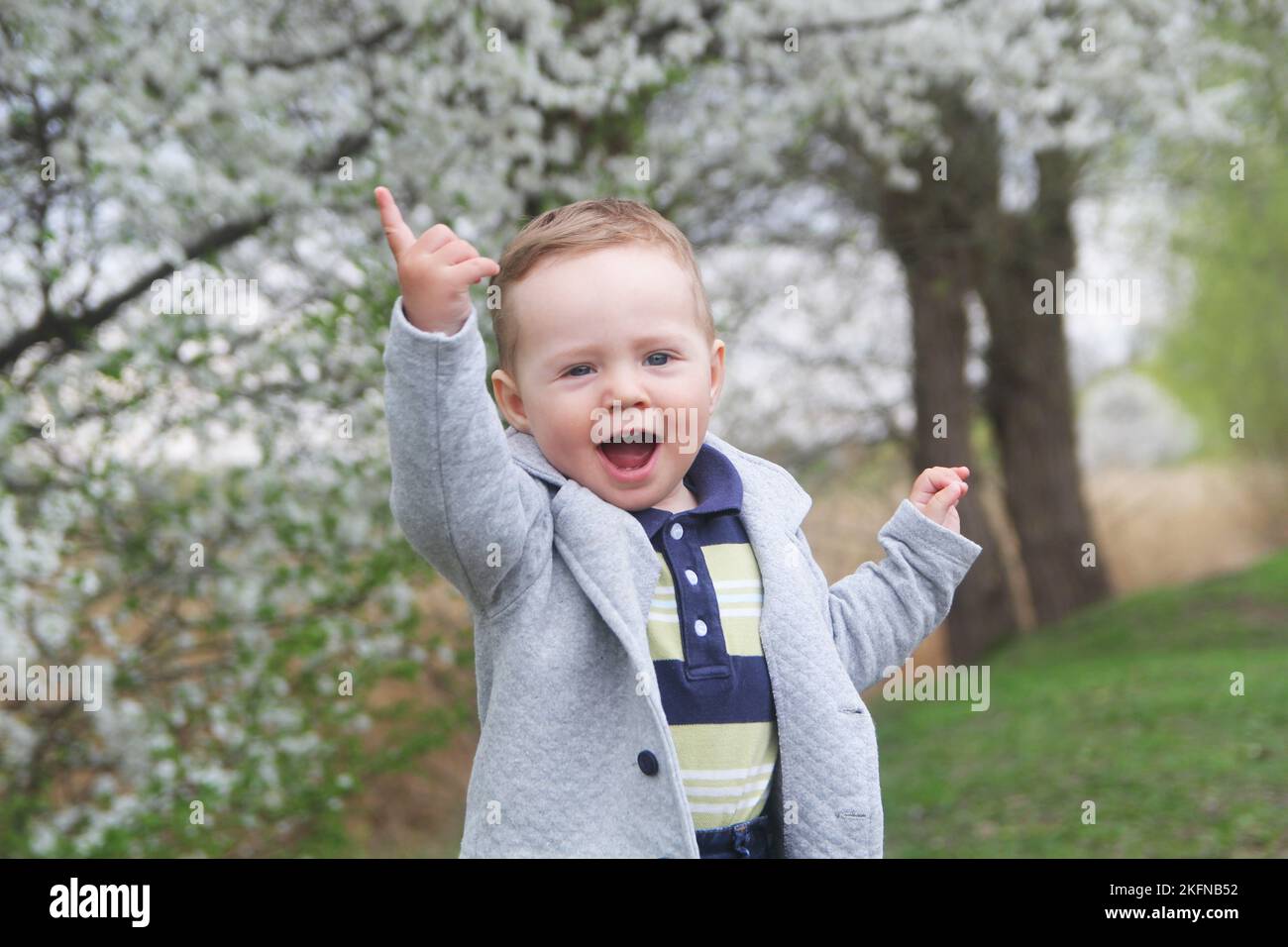 Beautiful cheerful child on the background of spring flowering Stock ...