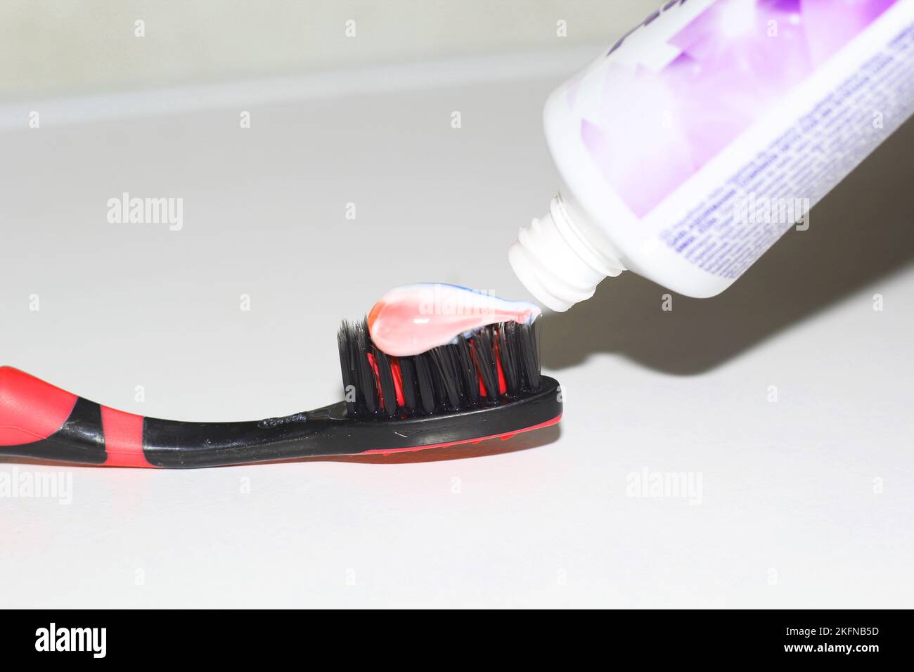 Toothpaste on a toothbrush close-up Stock Photo - Alamy