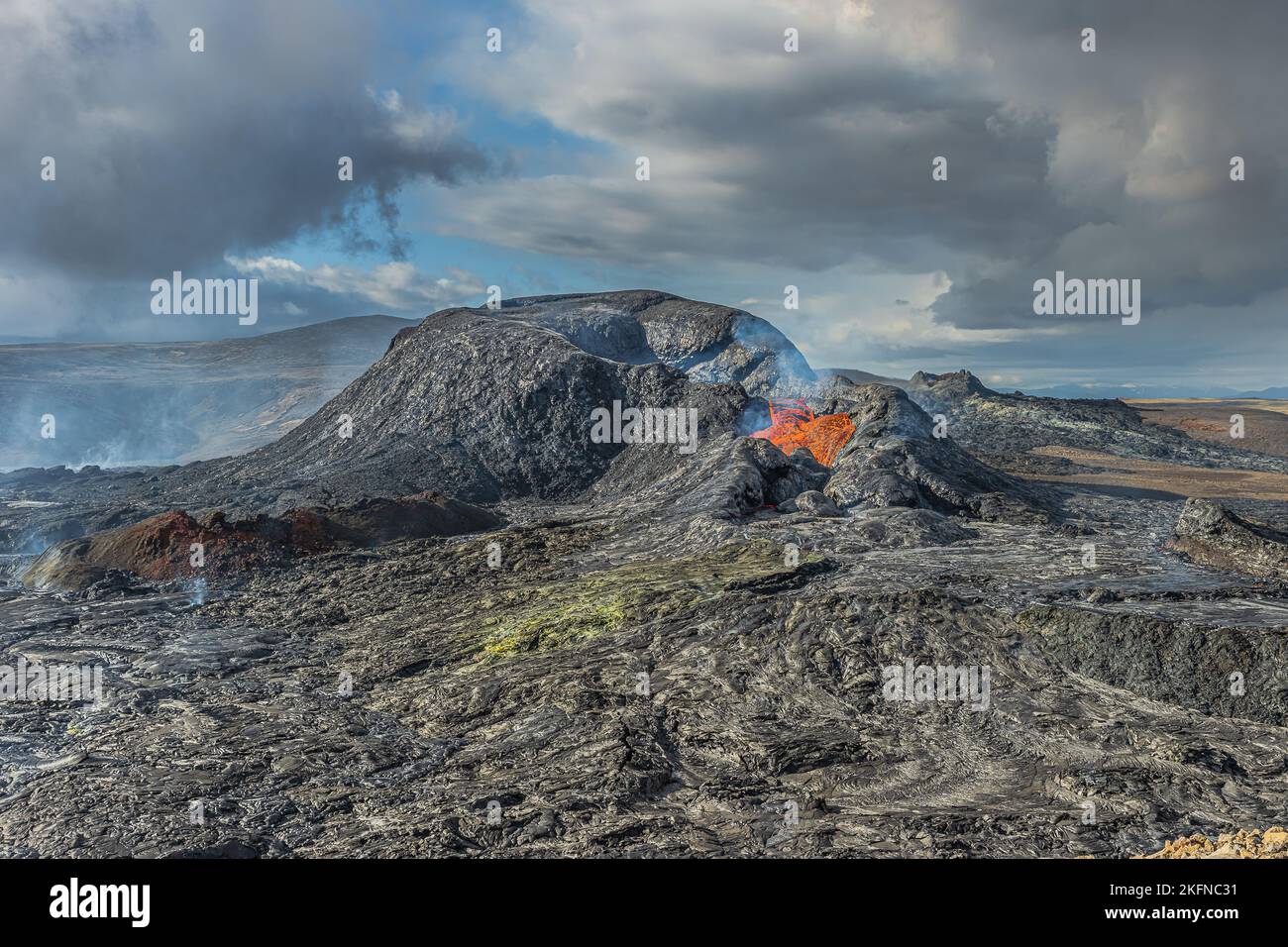 View of a volcanic landscape during the day with sunshine. active ...