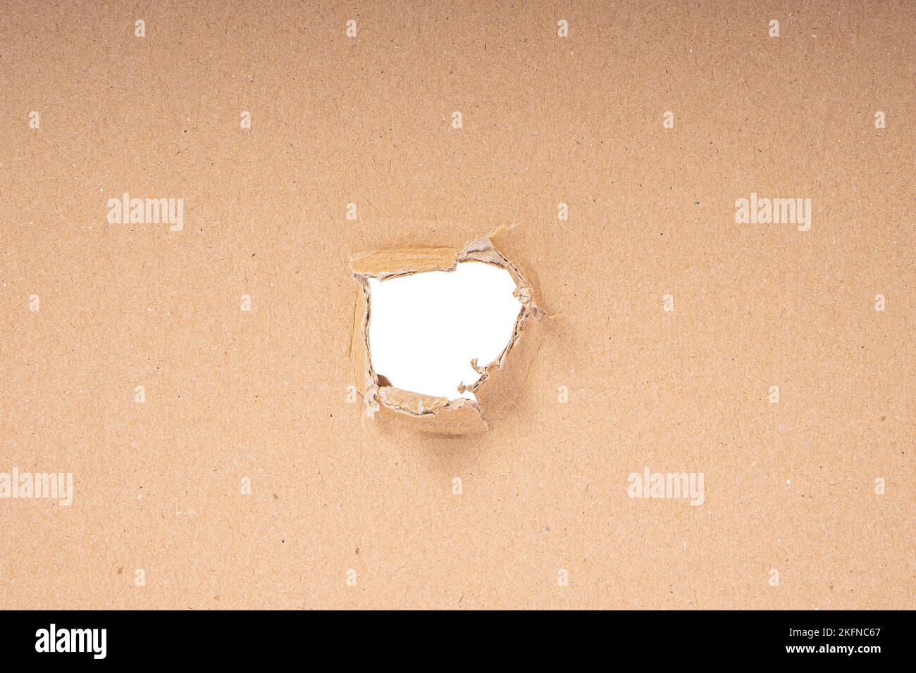 Ripped hole in cardboard on white background Stock Photo - Alamy