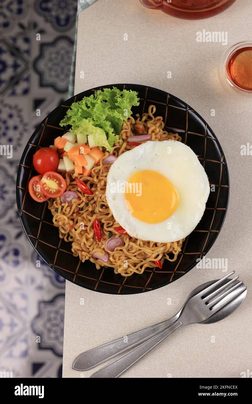 Indomie Goreng or Mie Goreng, Indonesian Popular Instant Noodle. Served ...