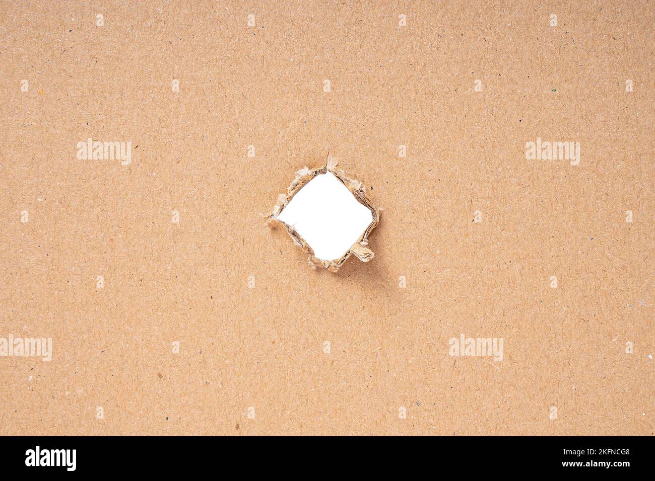 Ripped hole in cardboard on white background Stock Photo - Alamy