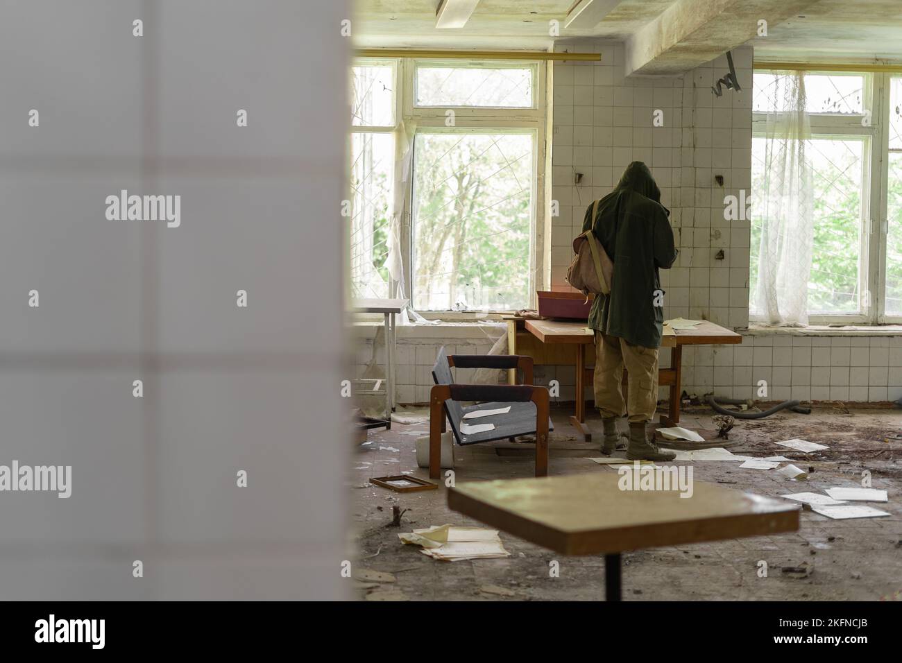 Back view of wandering man. Men walking in abandoned building. Post ...