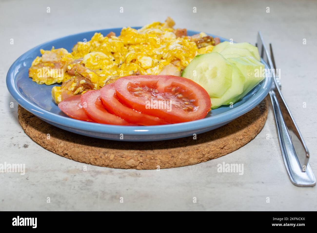 Scrambled eggs with bacon in a pan Stock Photo - Alamy
