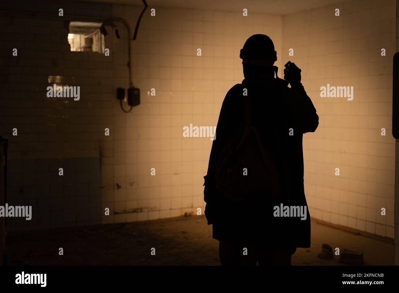 Environmental disaster. Post-apocalyptic survivor in gas mask on a dark ...