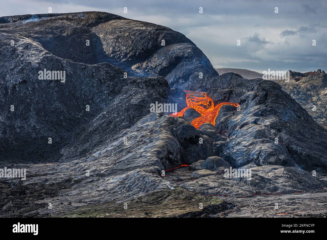 Initiating lava flow from an active volcano in Iceland. Landscape on ...