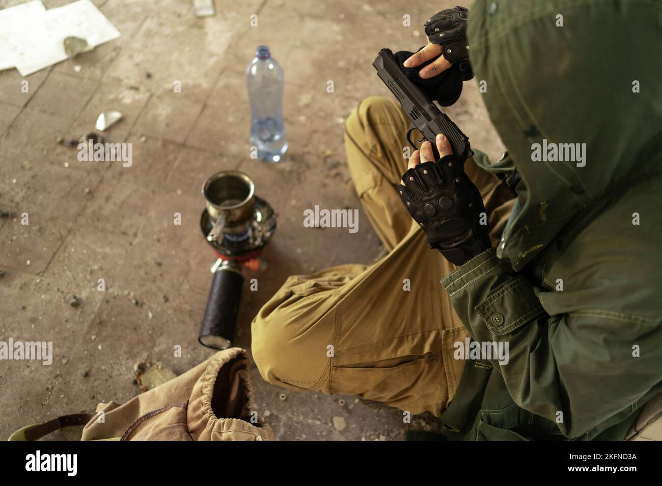 Post apocalypse, survivor, war. A man sitting in an abandoned building ...