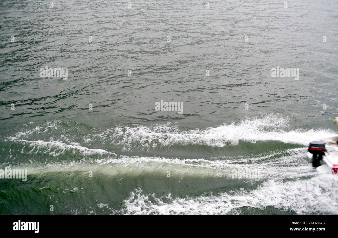 waves from a passing boat in lake. Stern wave from speed boat. Side ...