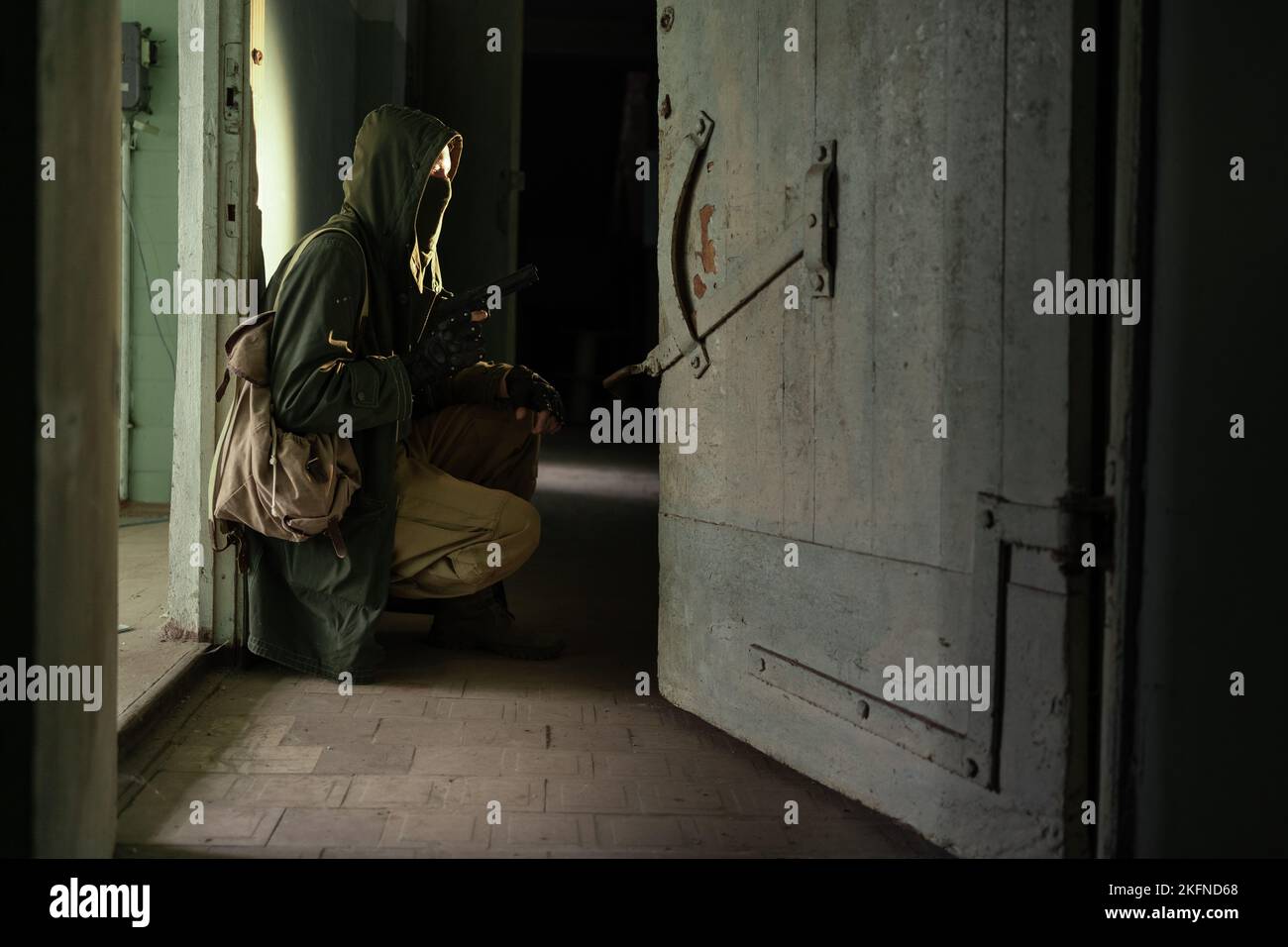 A post apocalypse soldier or stalker on a abandoned area with a gun and ...