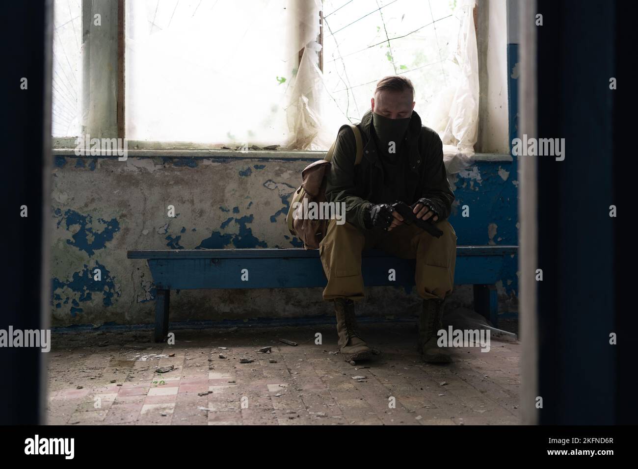 Tired post apocalyptic survivor with gun: environmental disaster, crime ...