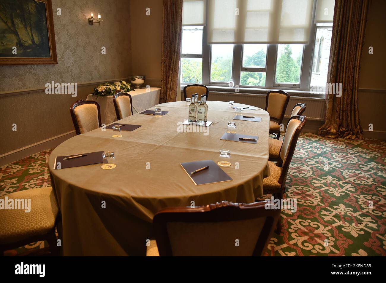 Large oval table set out for meeting in an old fashioned hotel ...