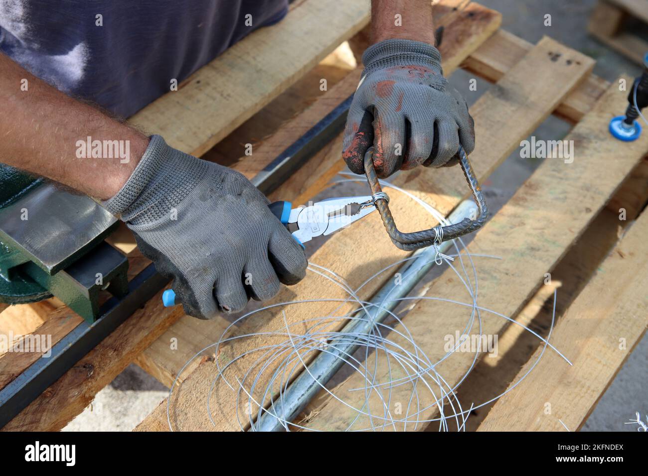 Close up photo of man holding pliers. Man works with reinforcement ...