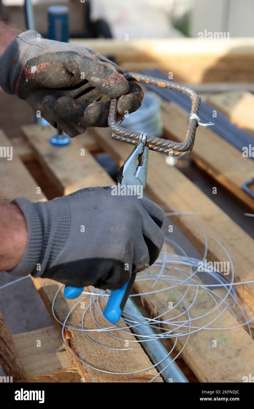 Hand holding reinforcement steel. Professional construction worker ...
